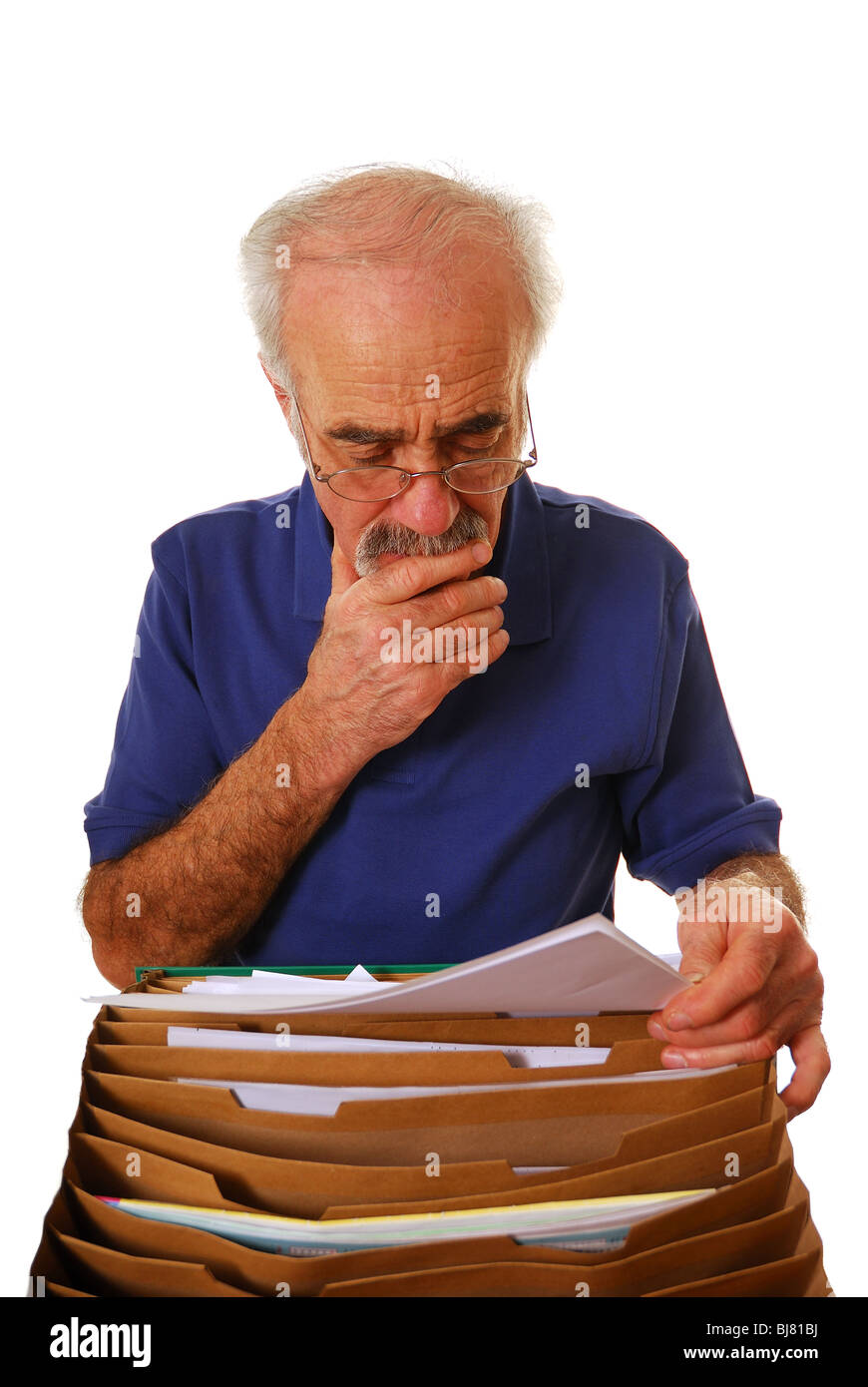 Elderly man looking through paperwork looking worried Stock Photo - Alamy