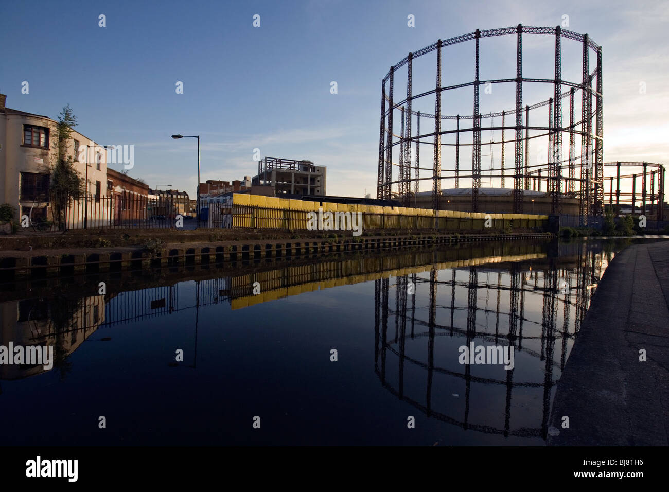 a hackney gas holder on the regents canal at sunset Stock Photo - Alamy