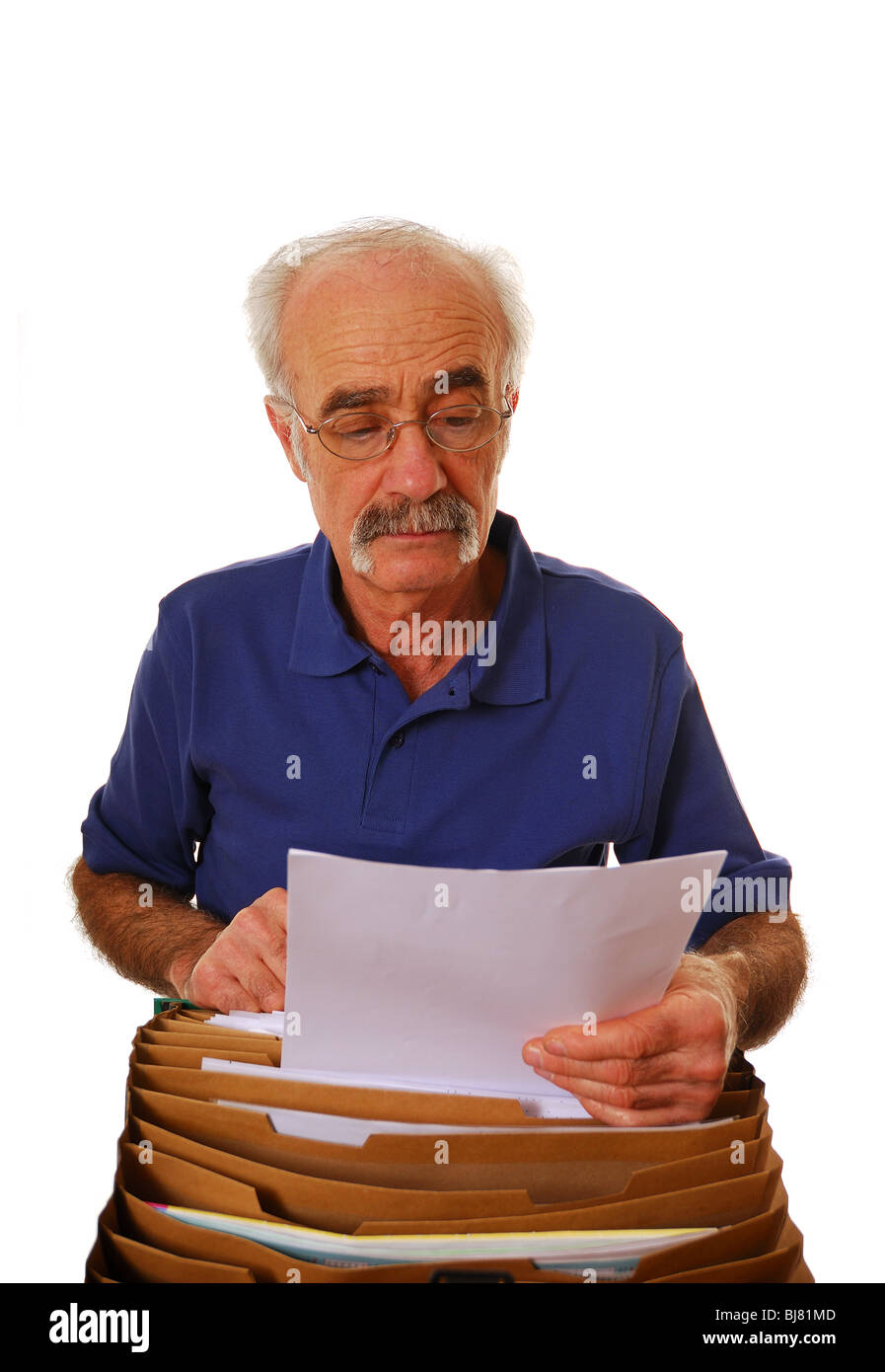 Elderly man looking through paperwork Stock Photo - Alamy