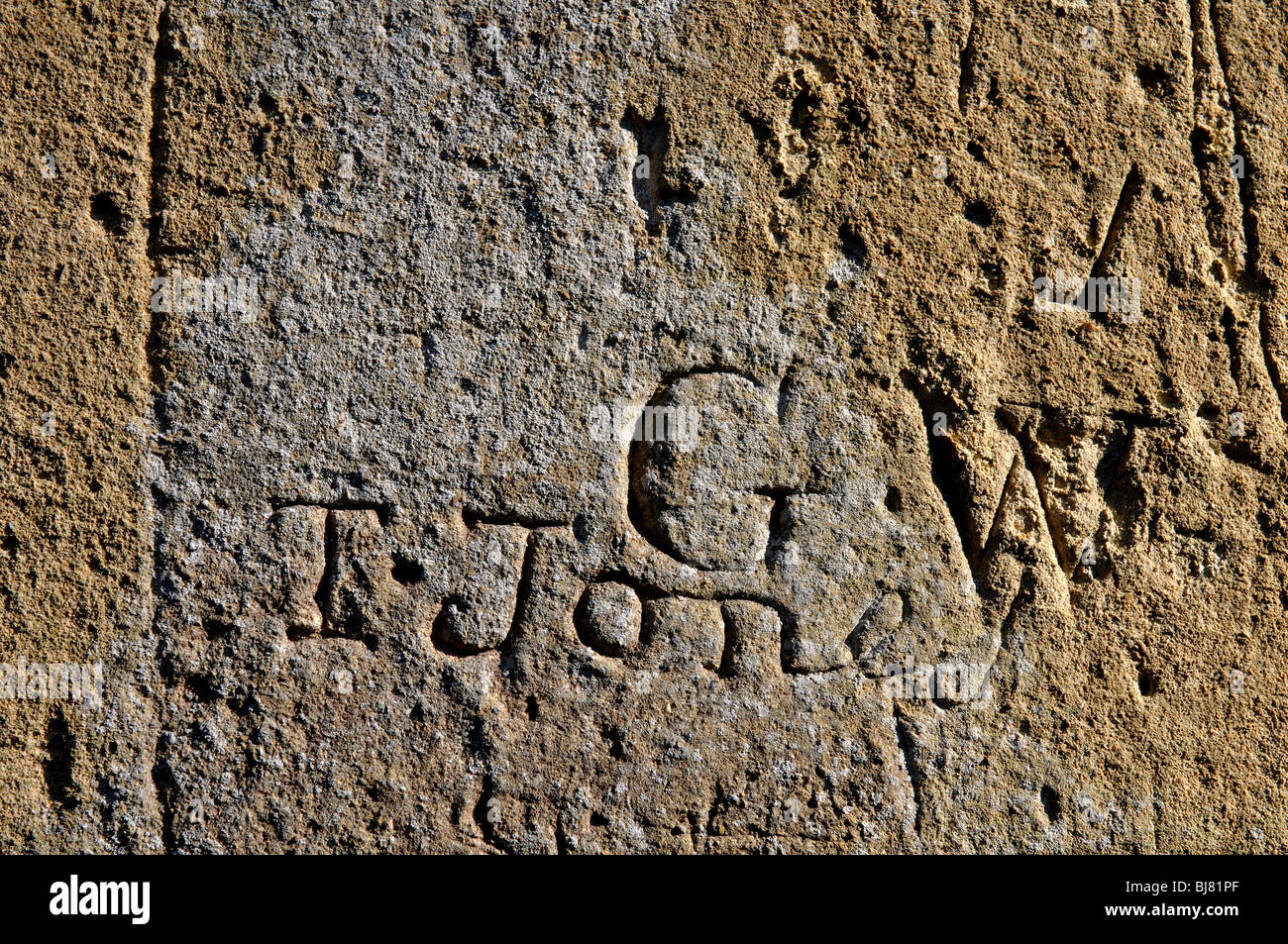 Names carved in outside wall by doorway of St. Mary`s Church, Deerhurst ...