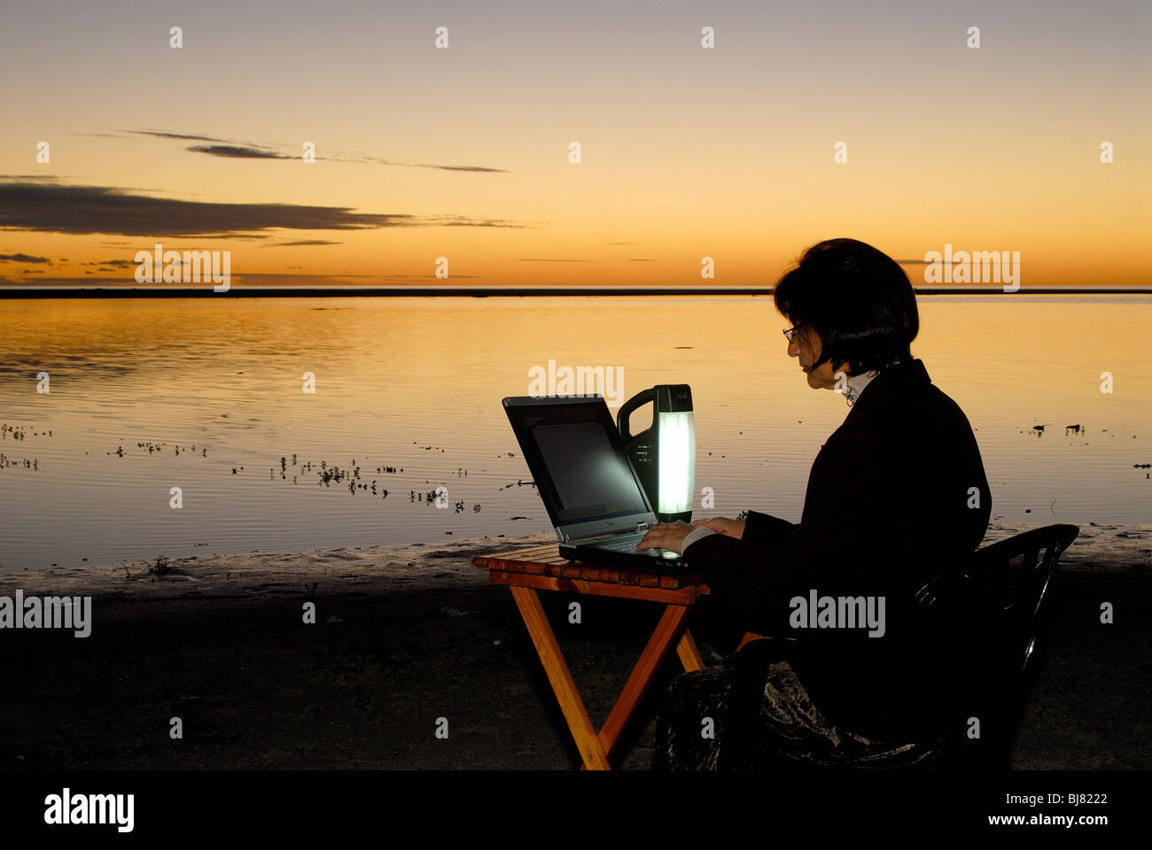 Freelance writer working in inspiring beach and sunset location Stock ...