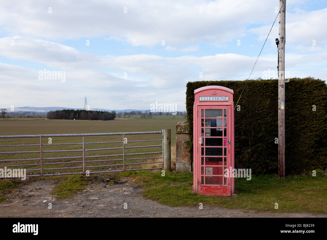 A faded red rural telephone box Stock Photo - Alamy