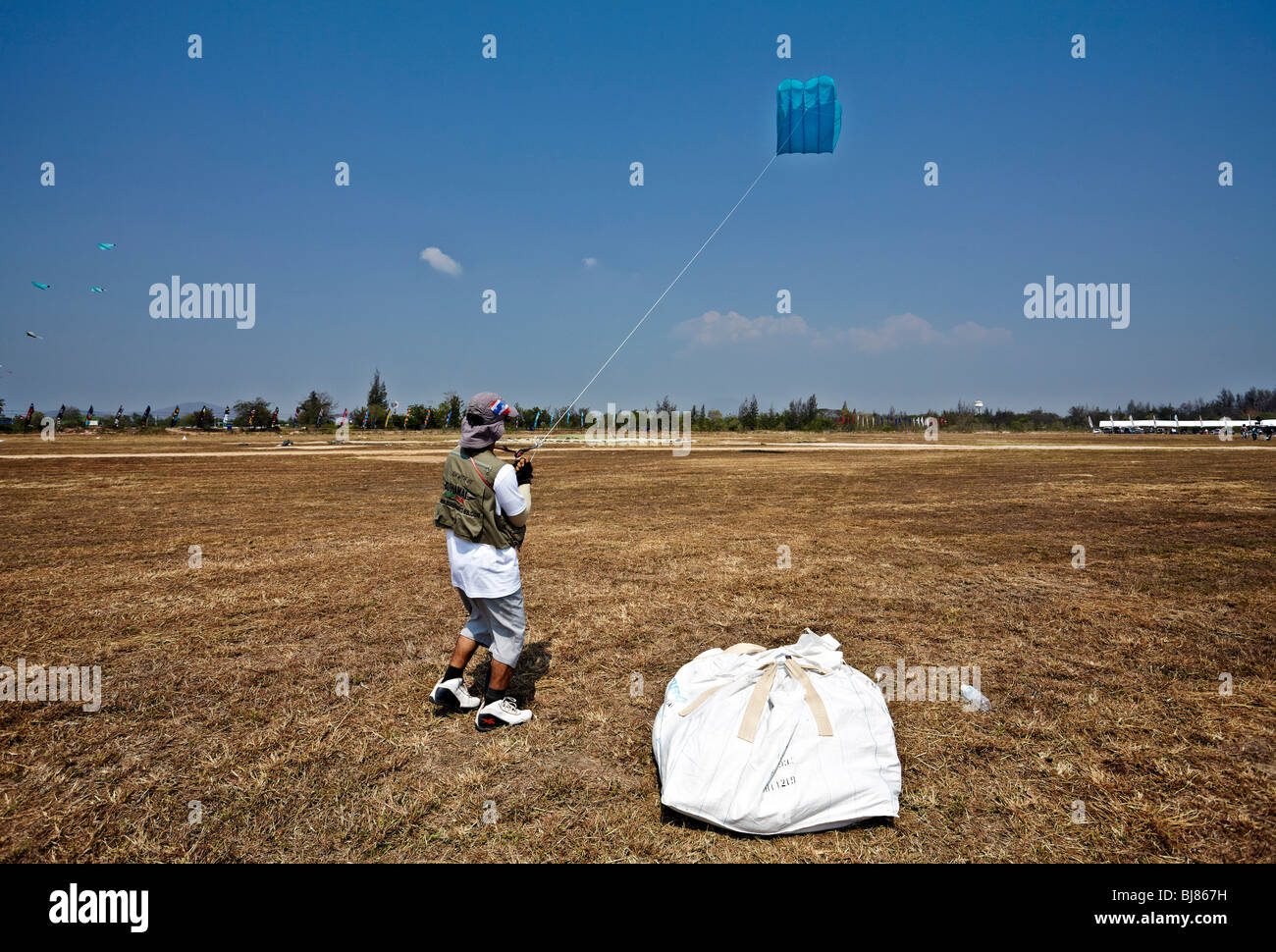 Kite flying blue sky. Kite flier at a kite flying event. Thailand S. E ...