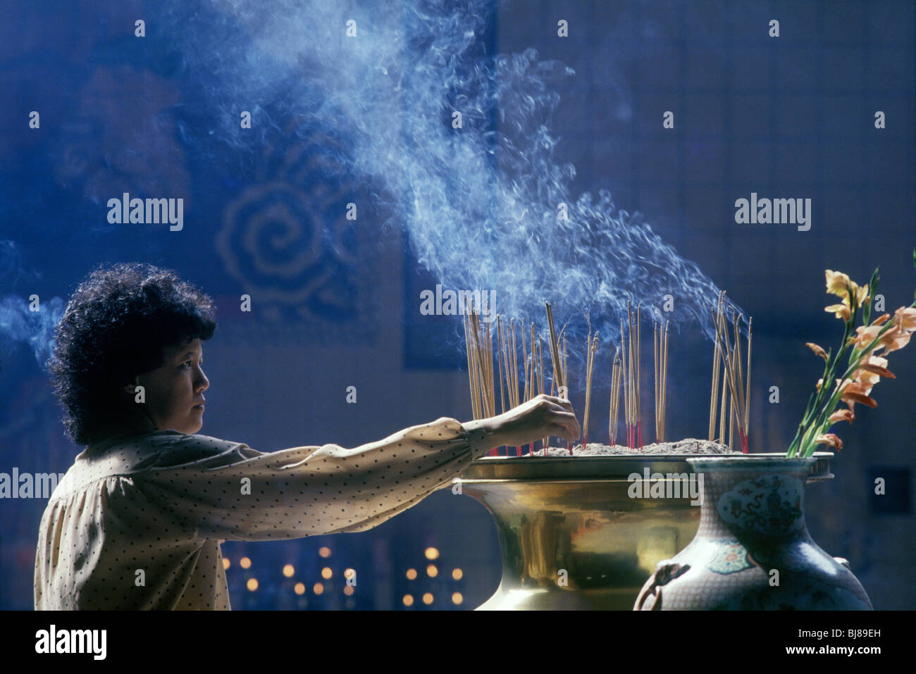 Devotee pray incense sticks hi-res stock photography and images - Alamy