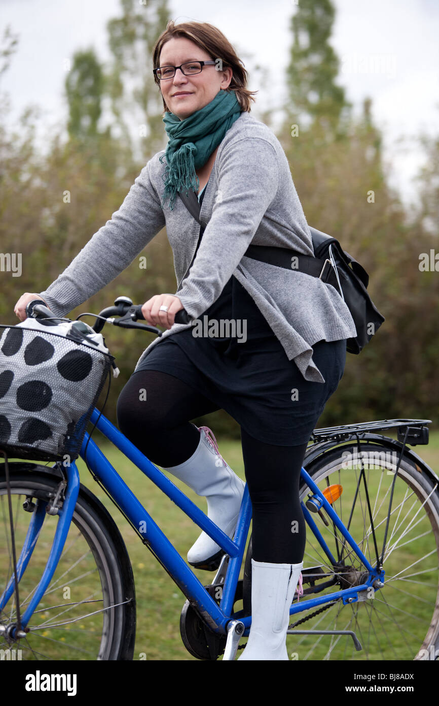 Adult female riding bicycle hi-res stock photography and images - Alamy