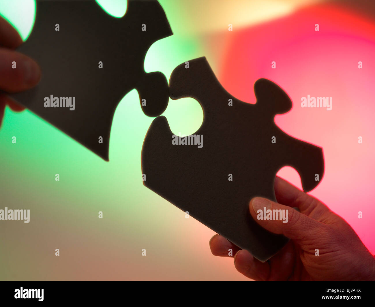 Jigsaw pieces being put together Stock Photo - Alamy