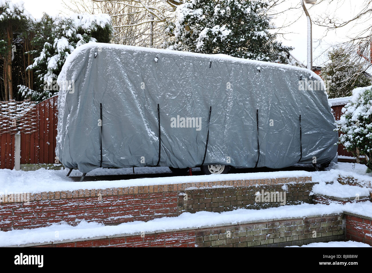 Touring Caravan with winter cover on it covered in snow Stock Photo - Alamy