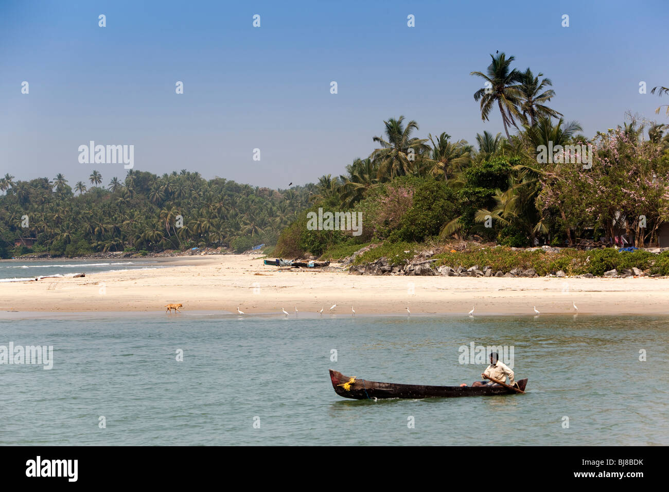 India, Kerala, Mahe (Pondicherry) Union Territory, man in dugout canoe ...