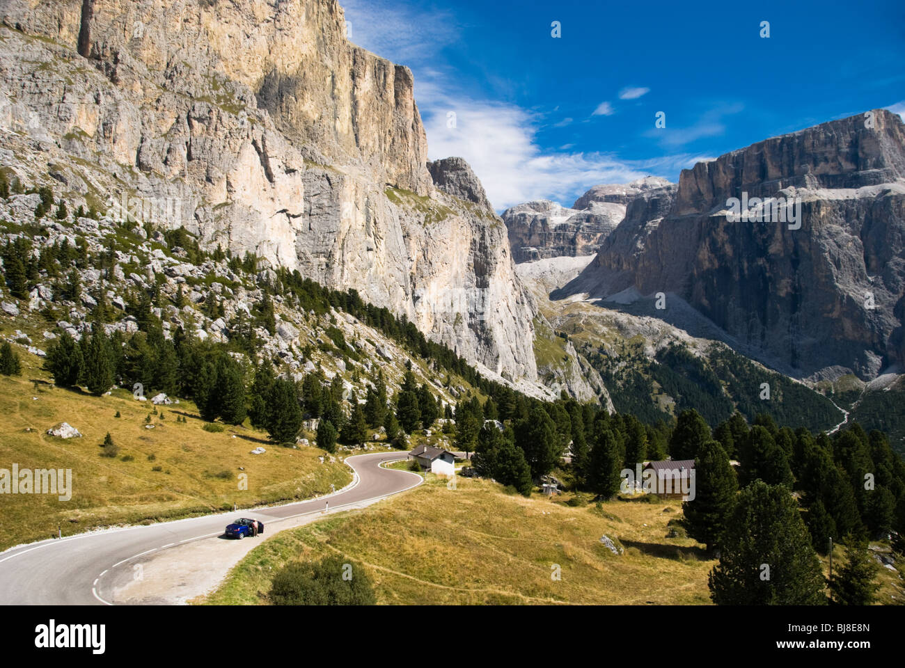 A tourist stops to admire the views of the Sella Massif in the Dolomite ...