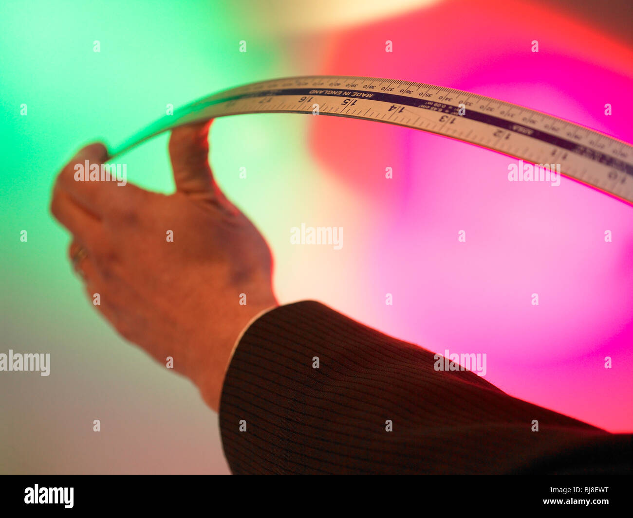 Hand bending a ruler Stock Photo - Alamy