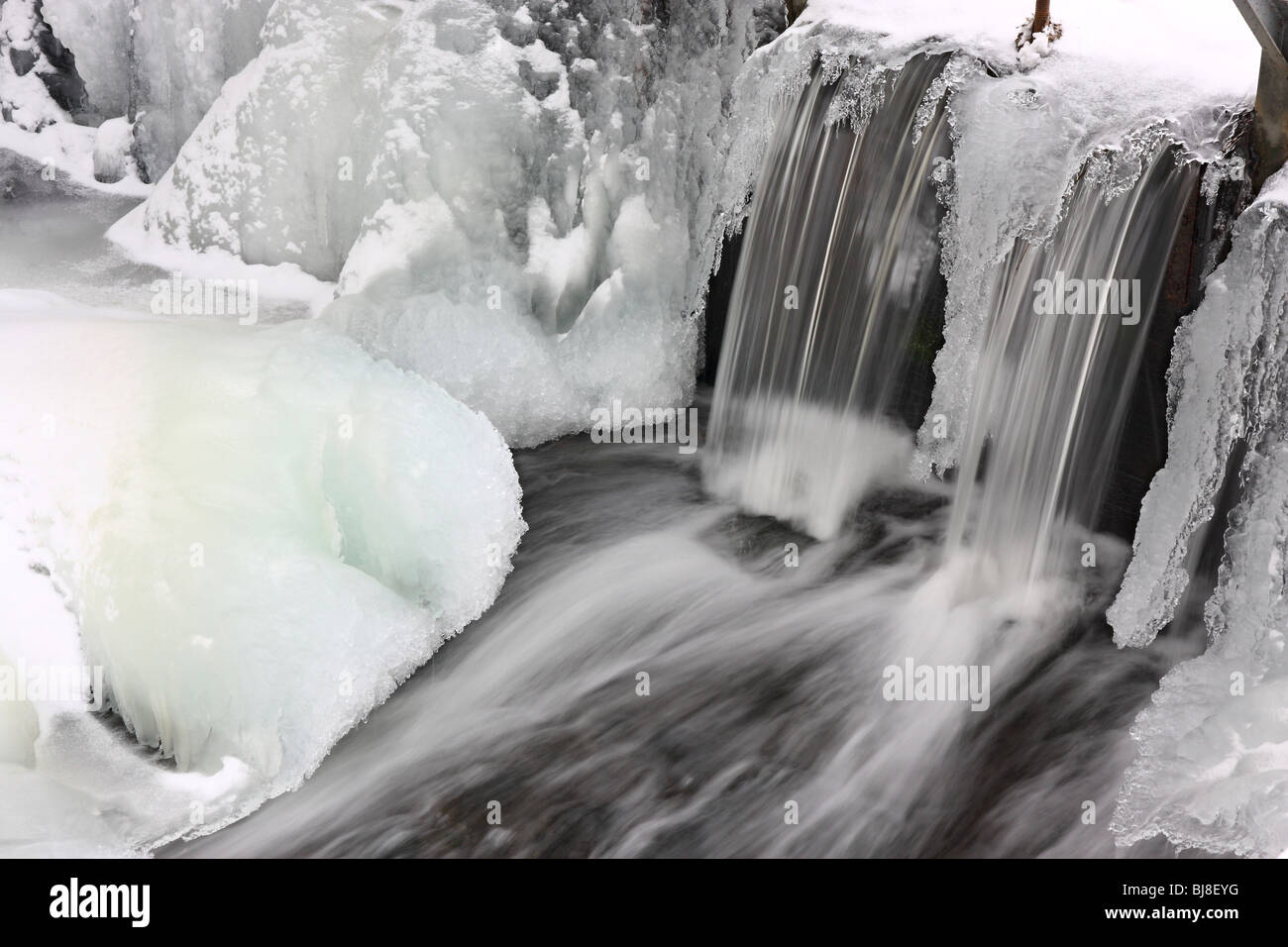 Winter stream with ice and waterfall Stock Photo - Alamy