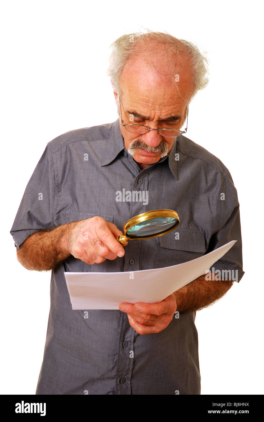 Old man trying to read small print using a magnifying glass and glasses ... Old man trying to read small print using a magnifying glass and glasses ...