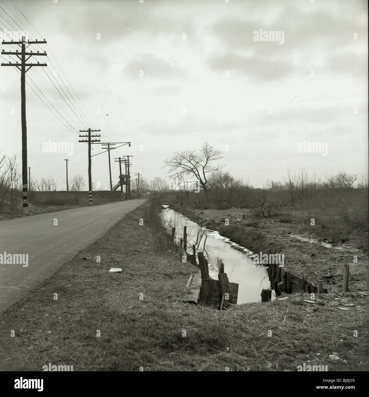 Rural scene outside Philadelphia with frozen winter creek telephone ...