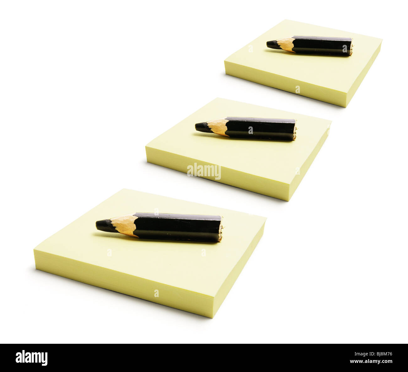Black Pencils on Post It Note Pads Stock Photo - Alamy