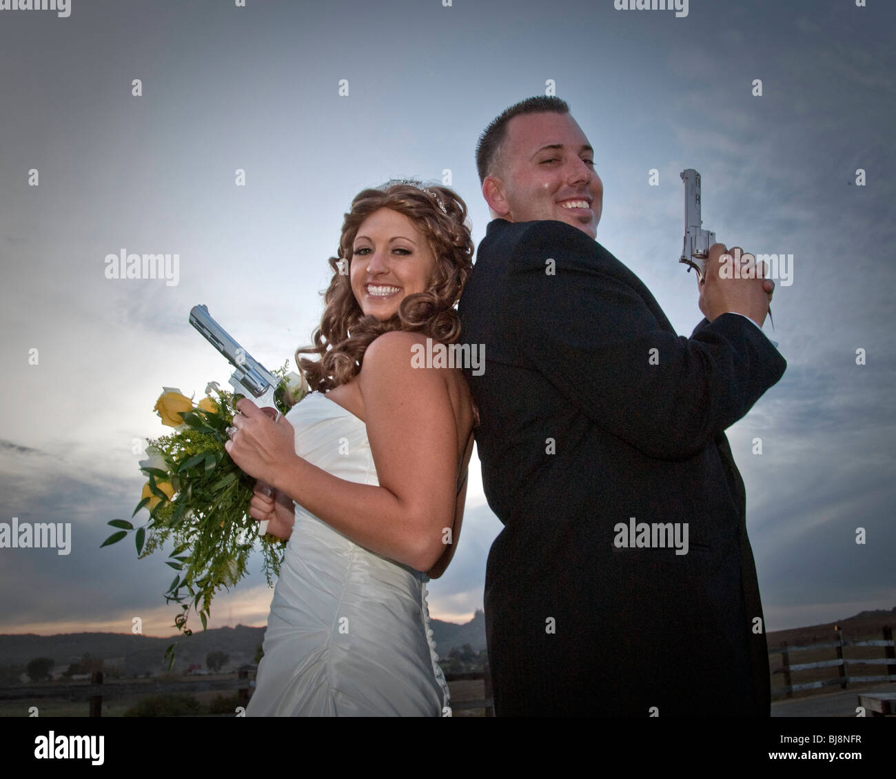 A couple stand back to back ready for a playful duel with cap guns at ...