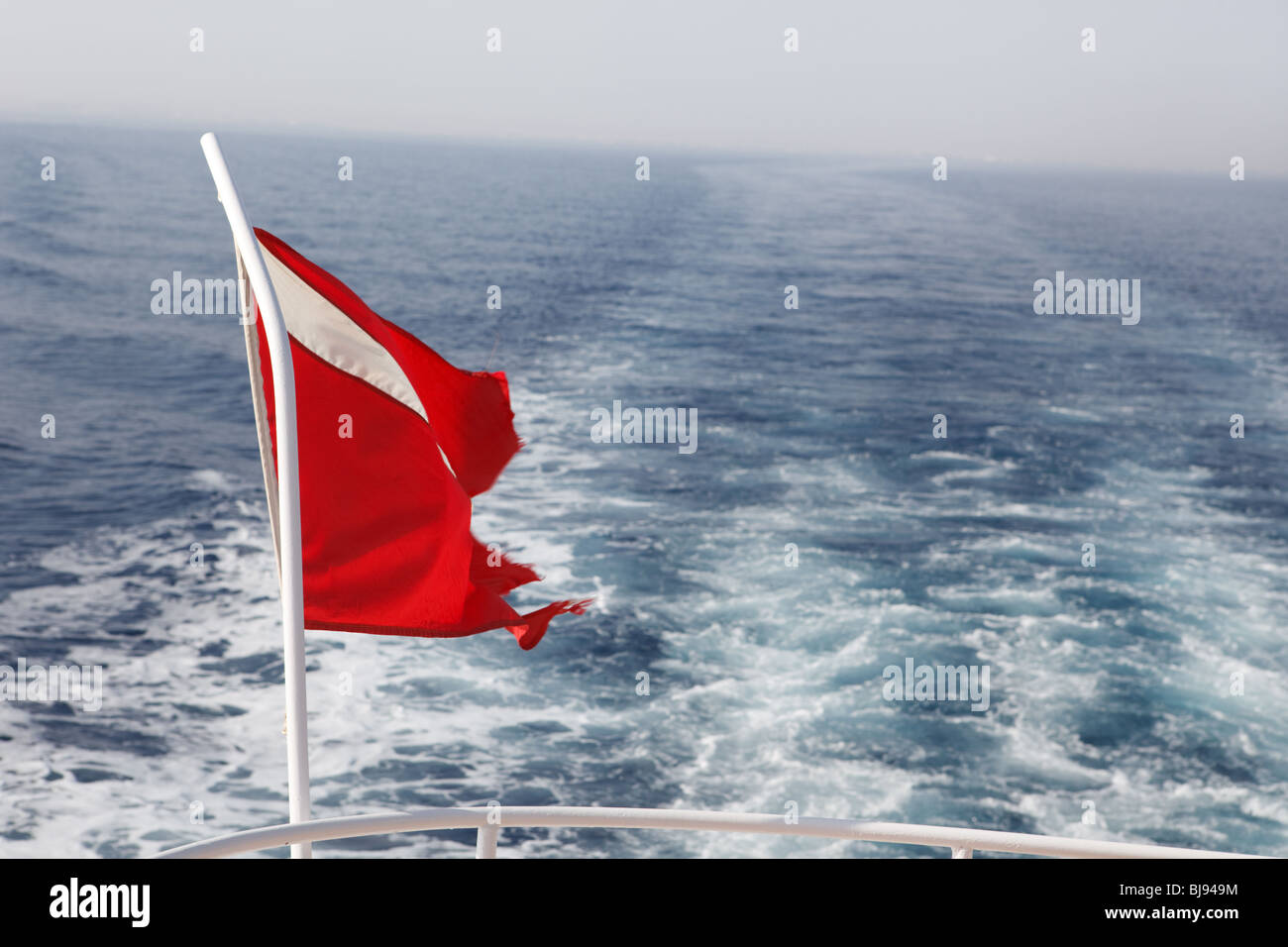 Moving dive boat with diver flag Stock Photo - Alamy
