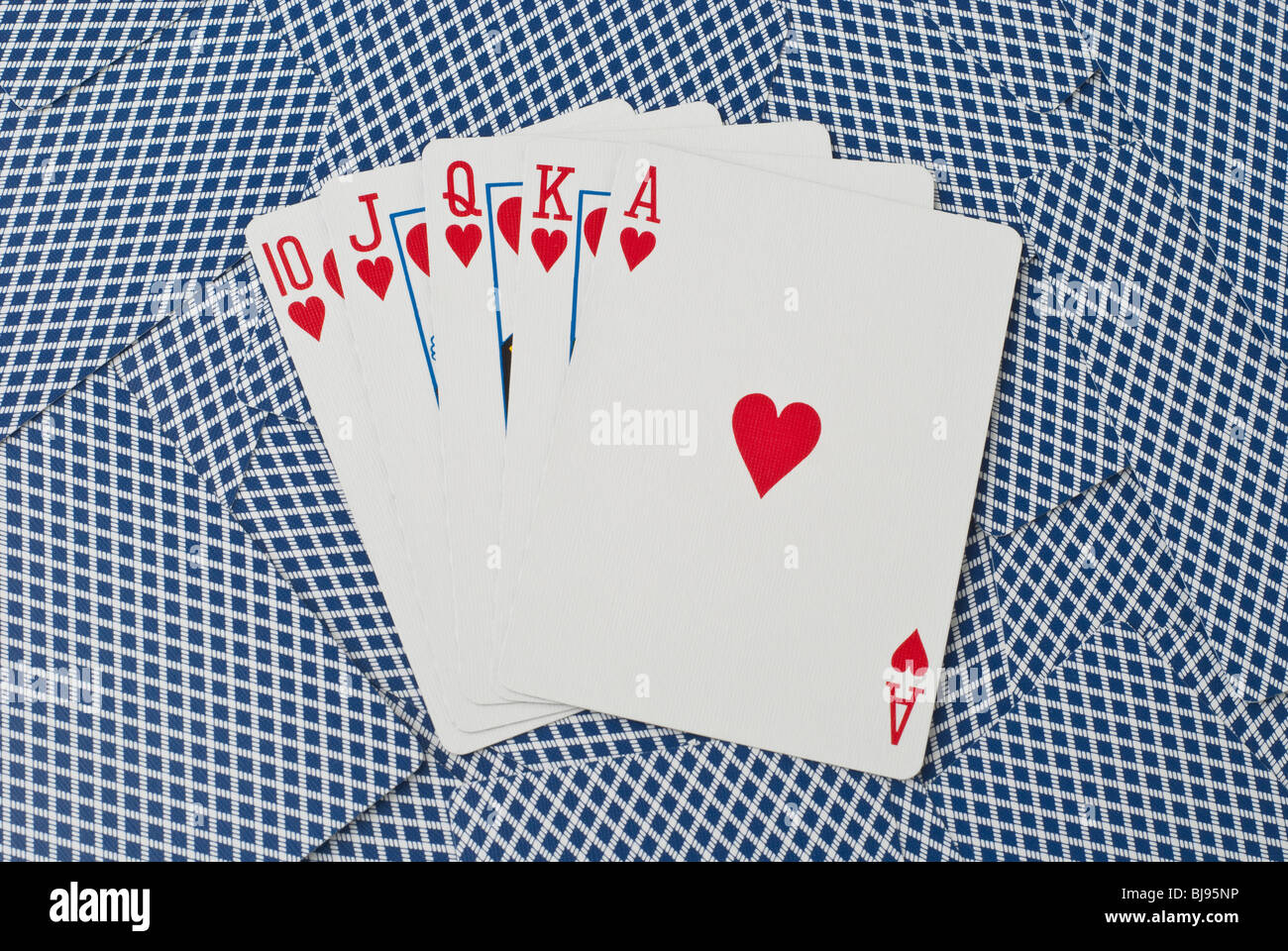 Five cards, showing a royal flush with hearts from ten to ace, on a ...