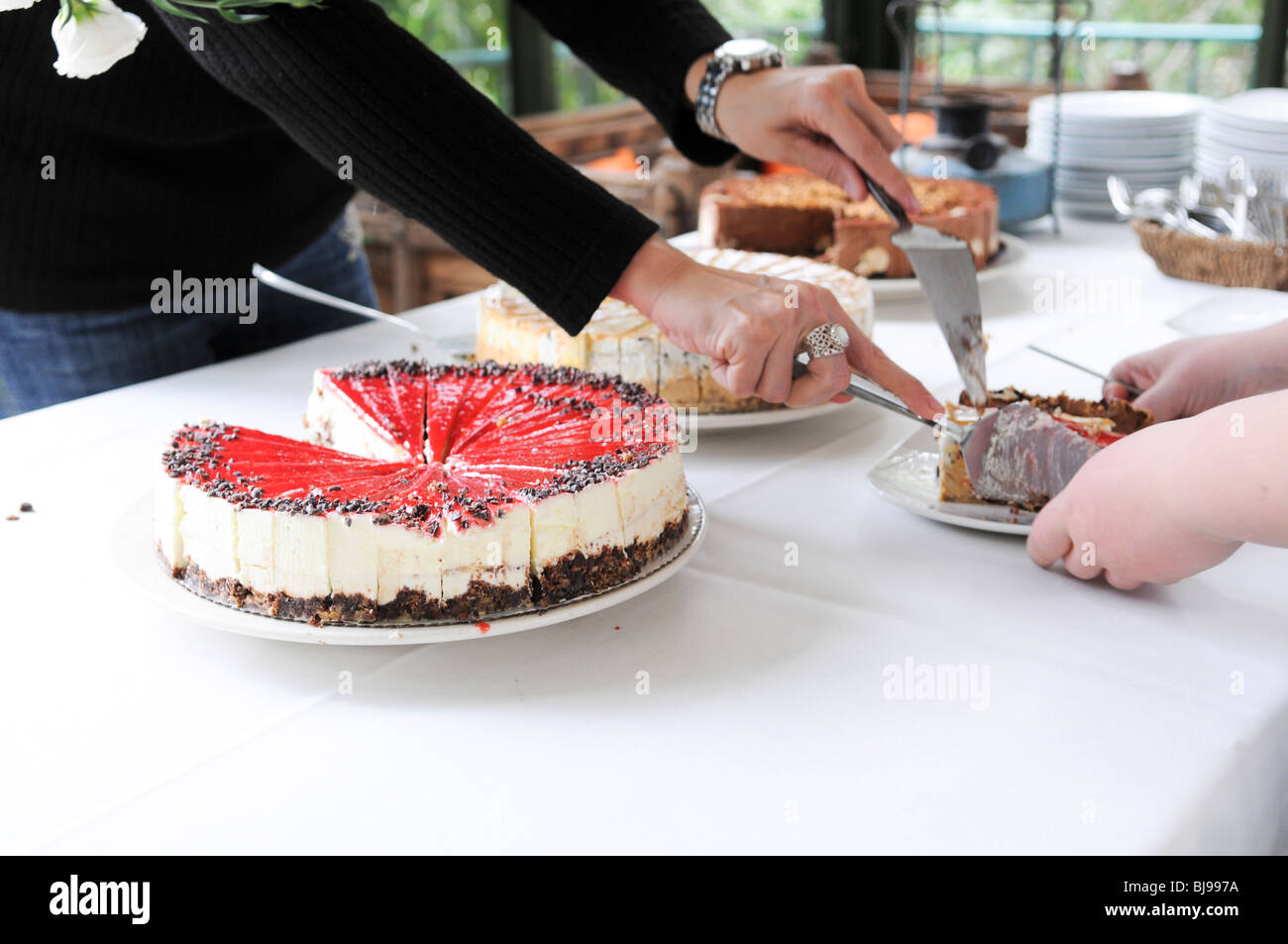 serving cream cake from a buffet dessert table Stock Photo - Alamy