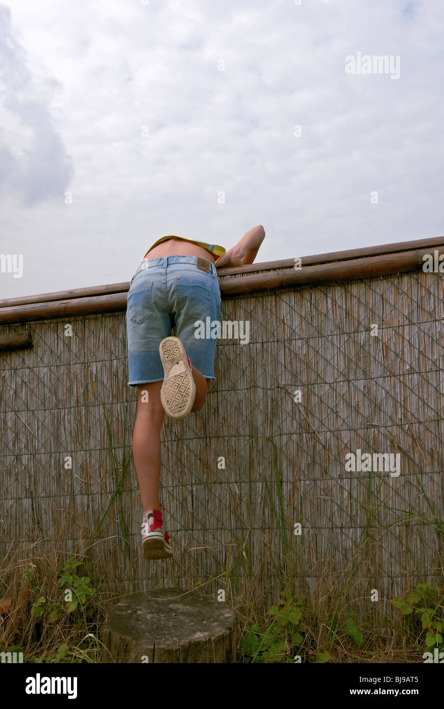 Girl leaning over fence hi-res stock photography and images - Alamy