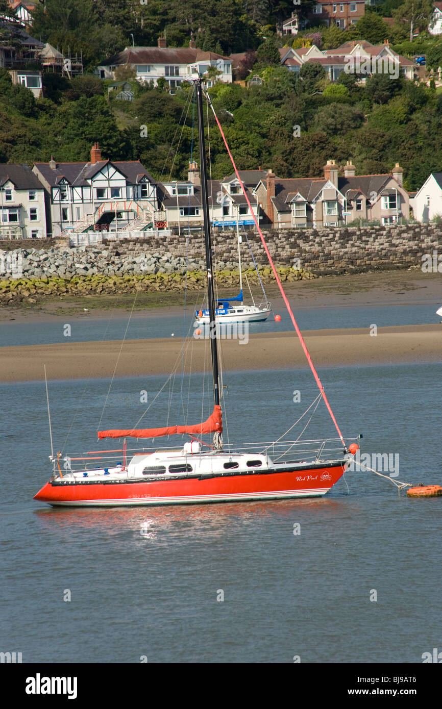 Red yacht Deganwy and the Conwy river from Conwy marina beach in North ...
