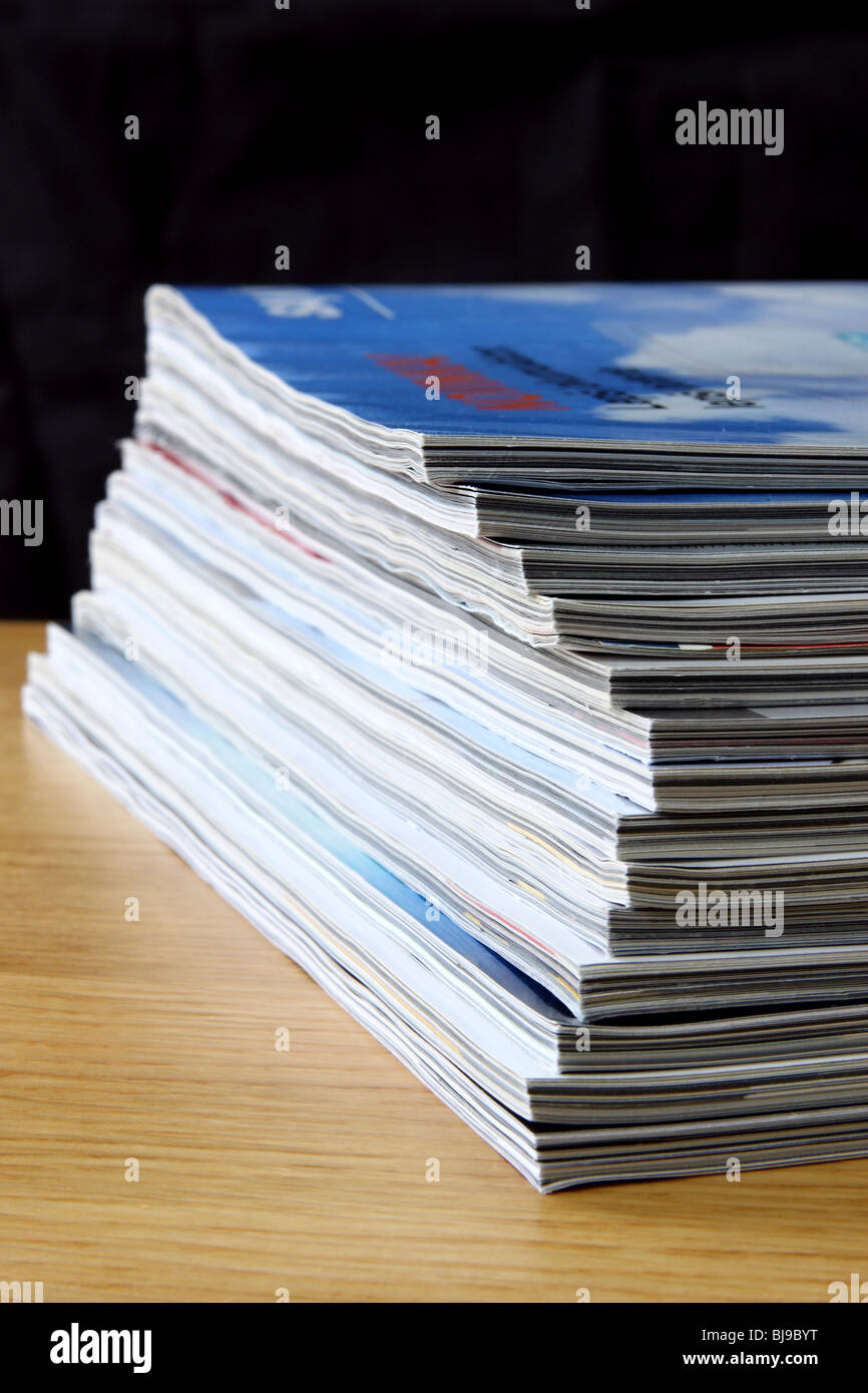 Pile of magazines on a wooden background Stock Photo - Alamy