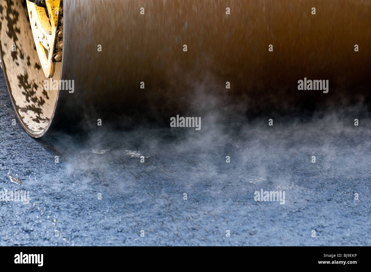Making new road. Roller press fresh tar. Motion blur Stock Photo - Alamy