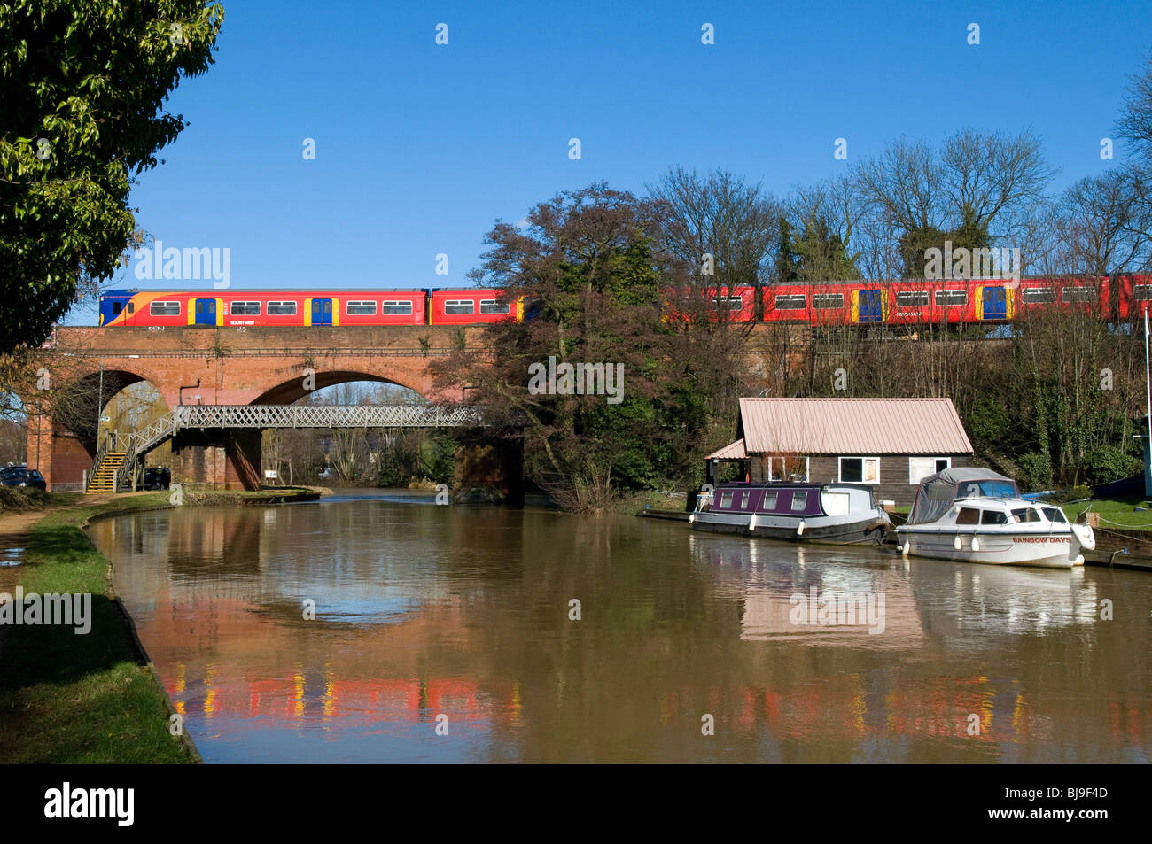 A Southwest train on railway bridge over river Wey in Guildford Stock ...