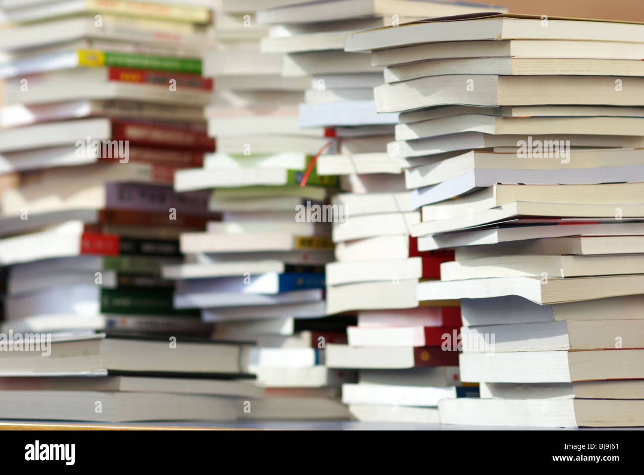 books piled on desk Stock Photo - Alamy