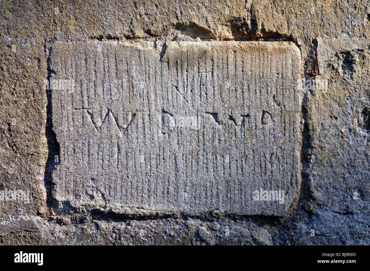 Initials carved in outside wall by doorway of St. Mary`s Church ...