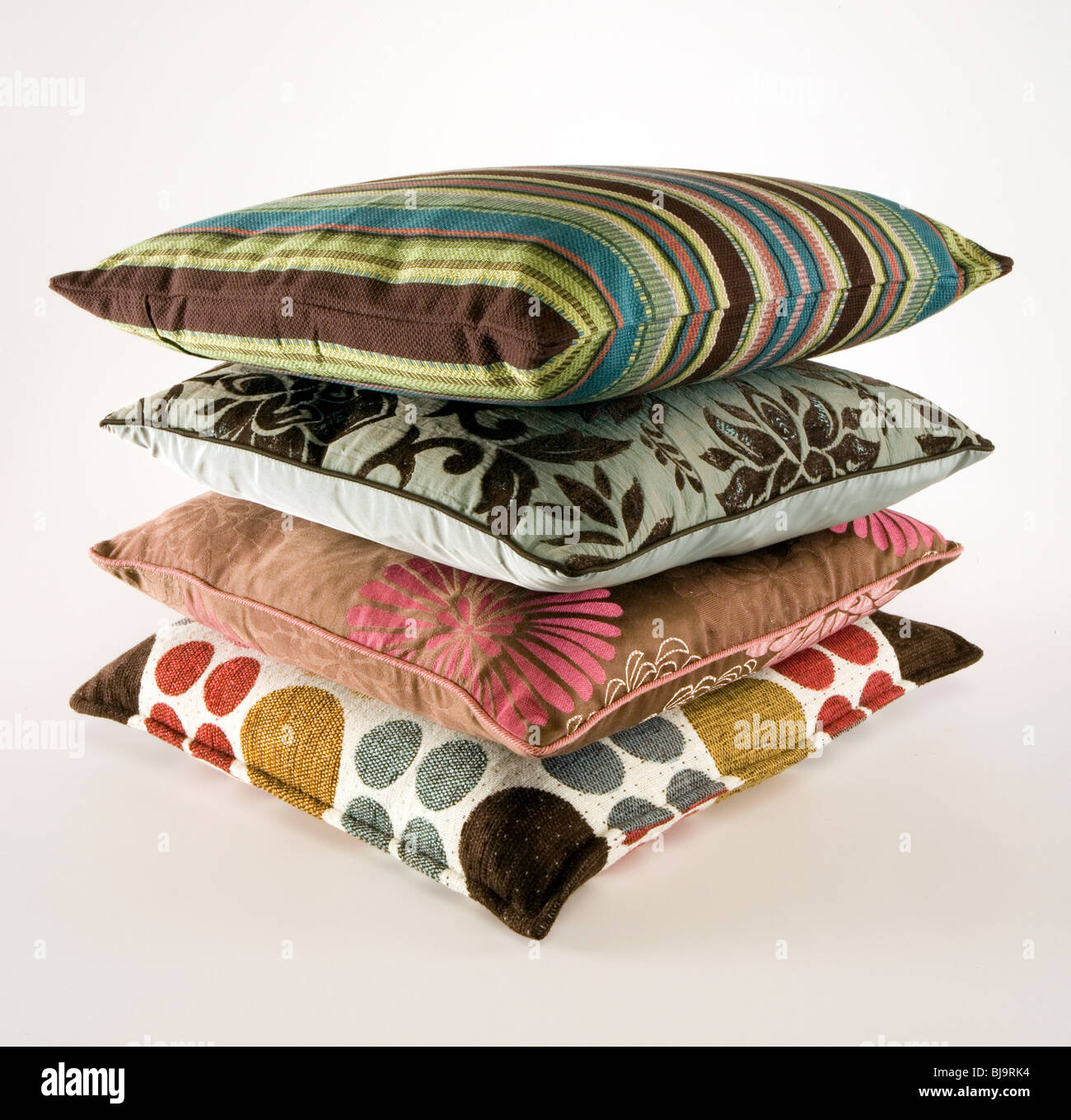 Pile of square cushions in various patterns on white background Stock ...