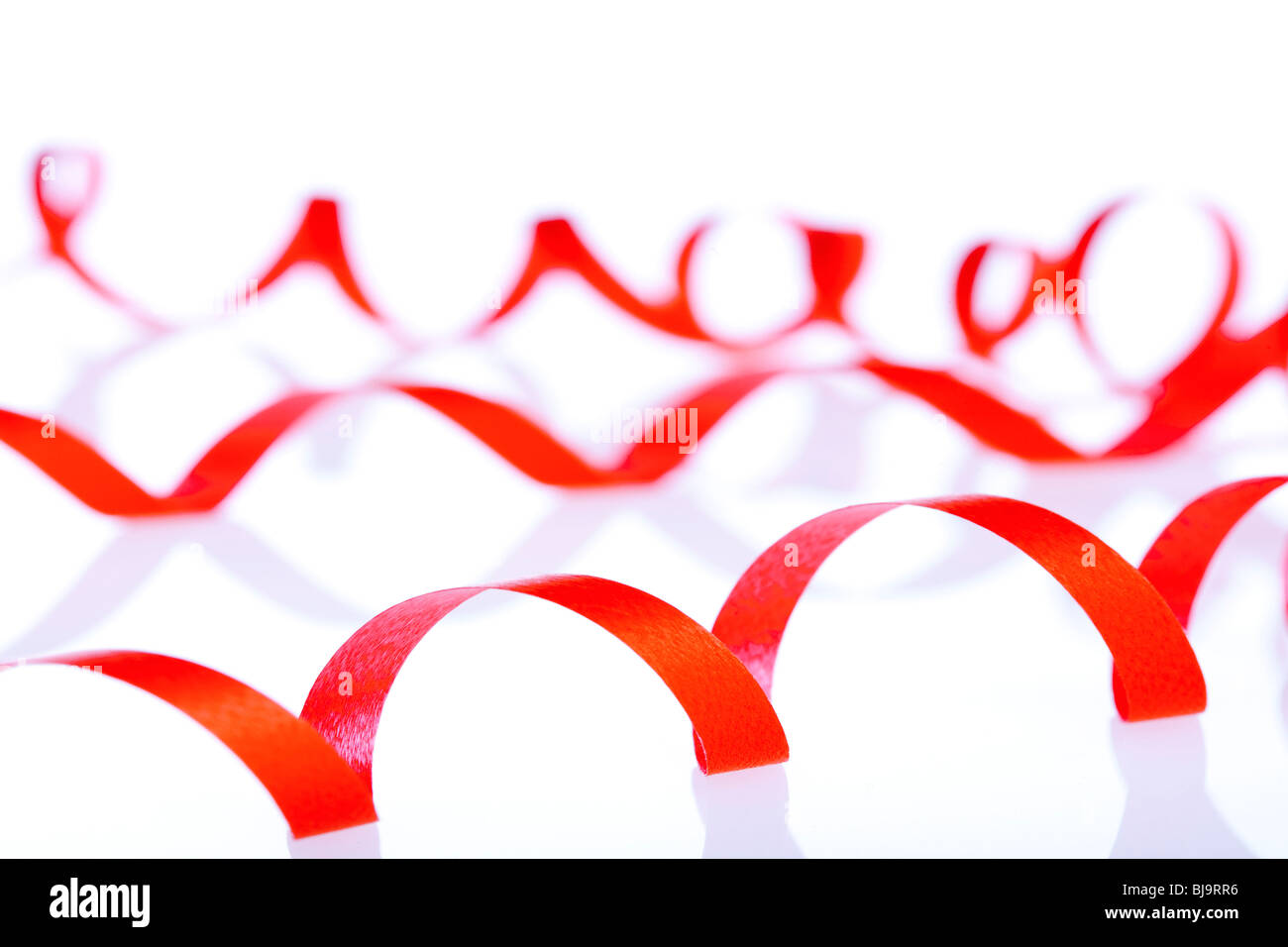 red decorative ribbon in curvy lines isolated on white Stock Photo - Alamy