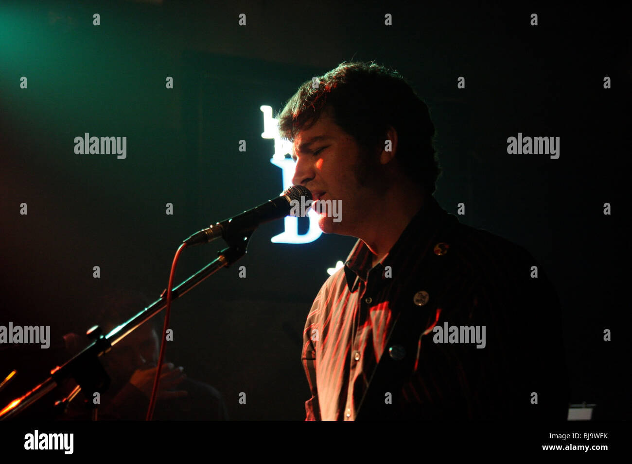 Band singer and guitar player performing at a gig Stock Photo - Alamy