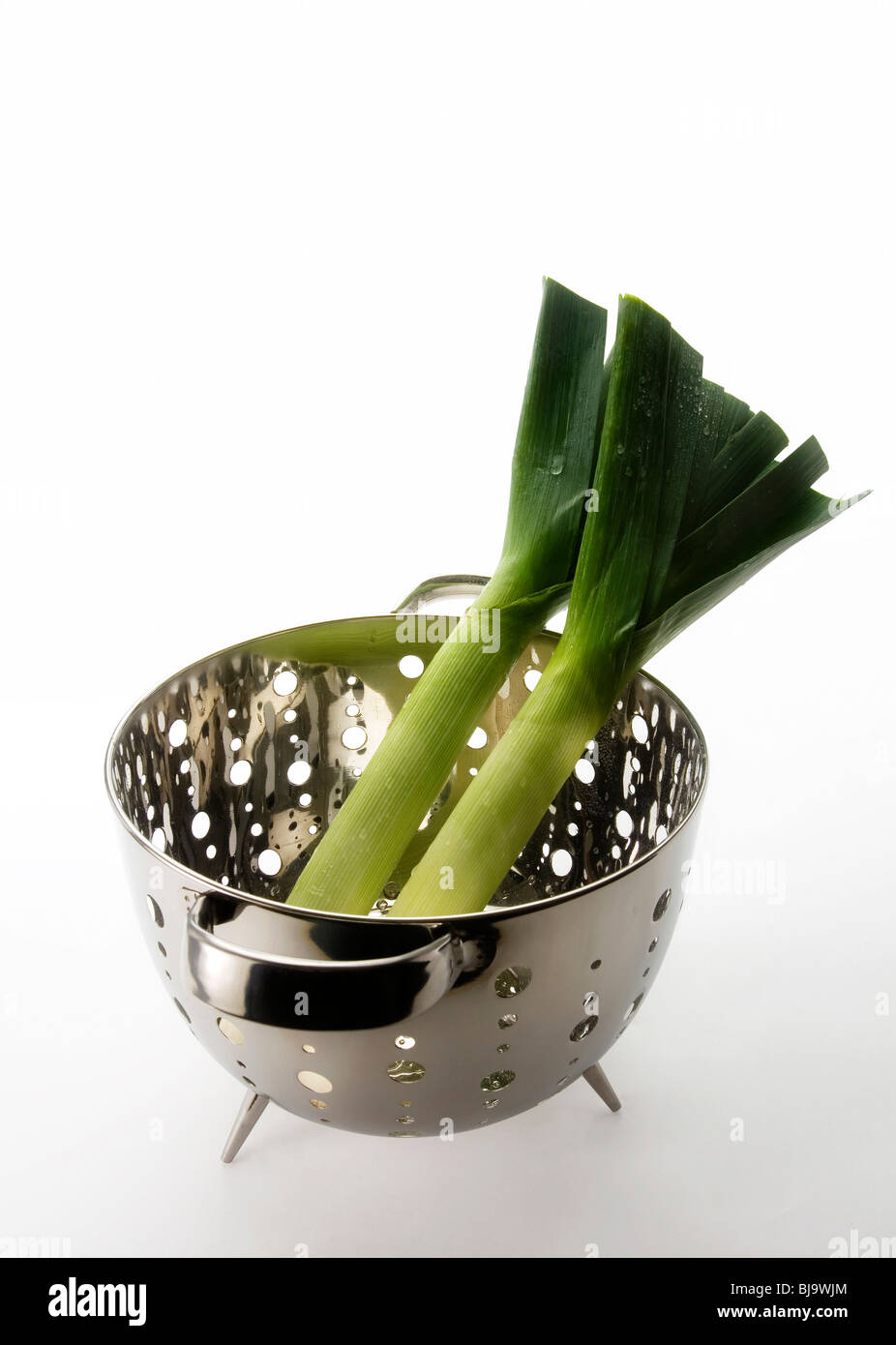 Two leeks in a collander Stock Photo - Alamy