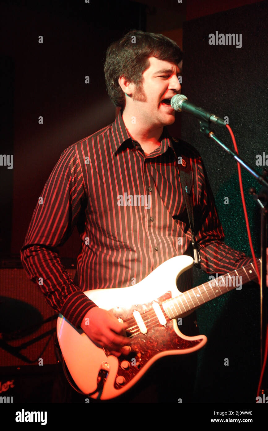 Band singer and guitar player performing at a gig Stock Photo - Alamy