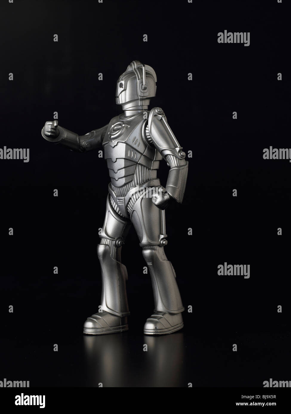 Robot man on black background shown in full length looking to the side ...