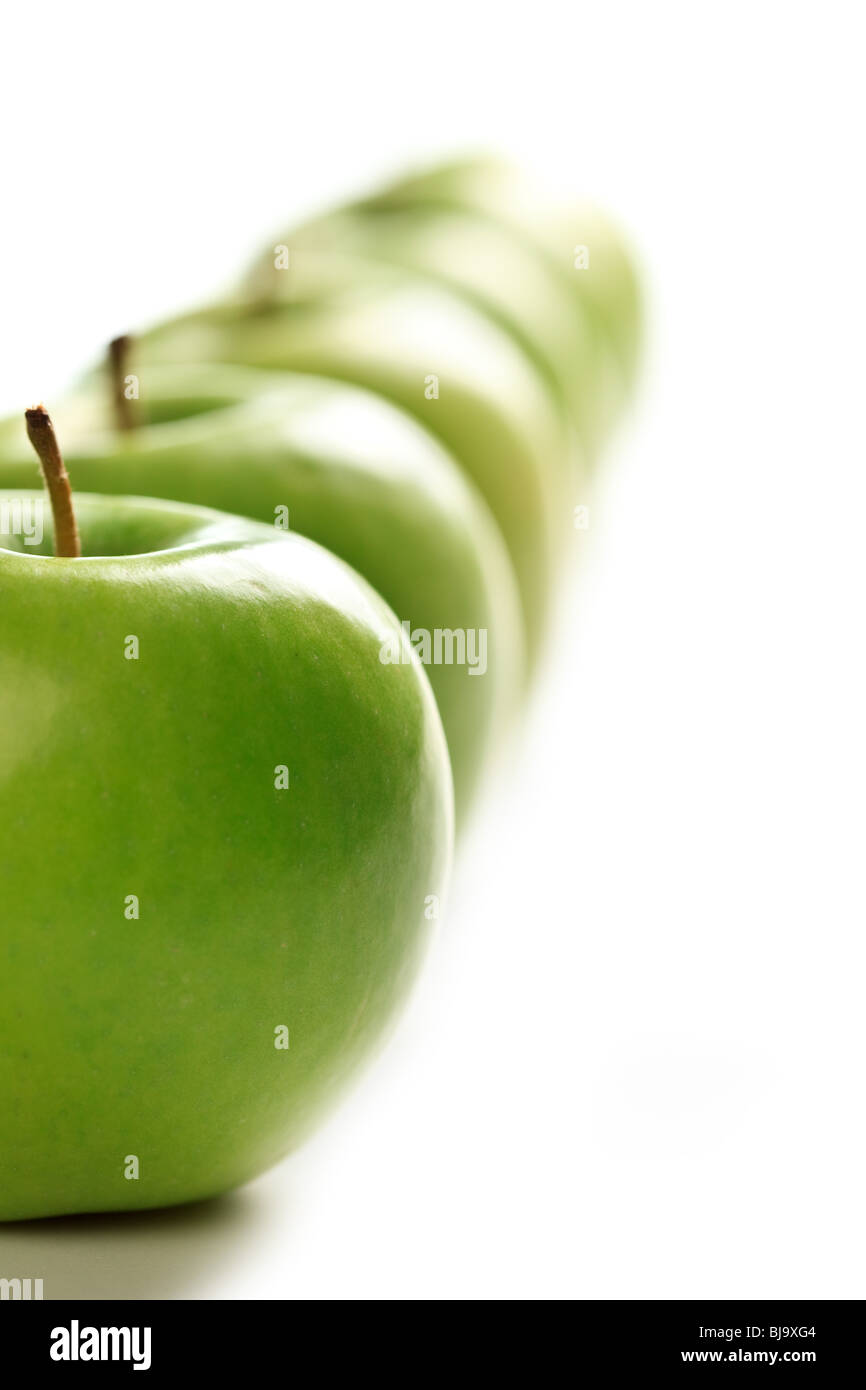 photo shot of line of green apples Stock Photo - Alamy