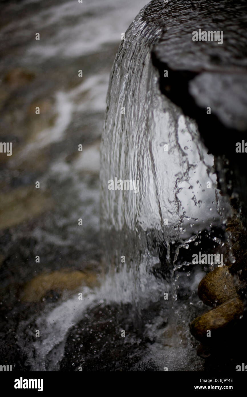Water Falling from collapsed roadway down river stream Stock Photo - Alamy