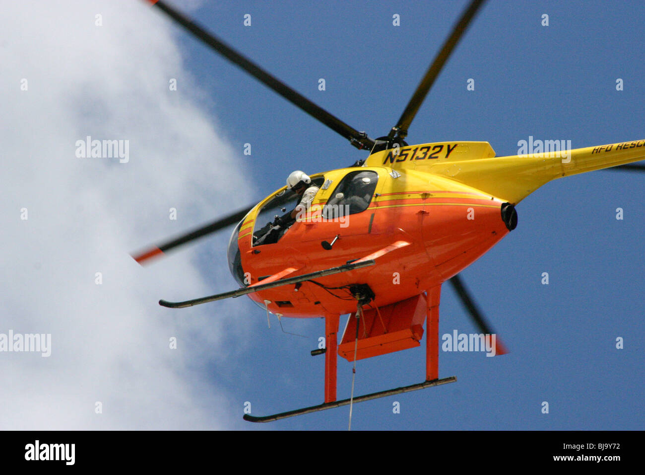 Search and Rescue helicopter and pilot hovering with sling load. This ...