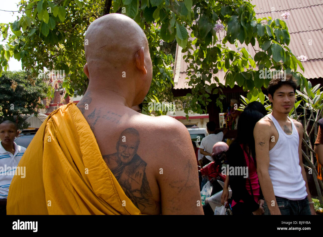 A monk with a tattooed back at Wat Bang Phra temple in Thailand, where ...