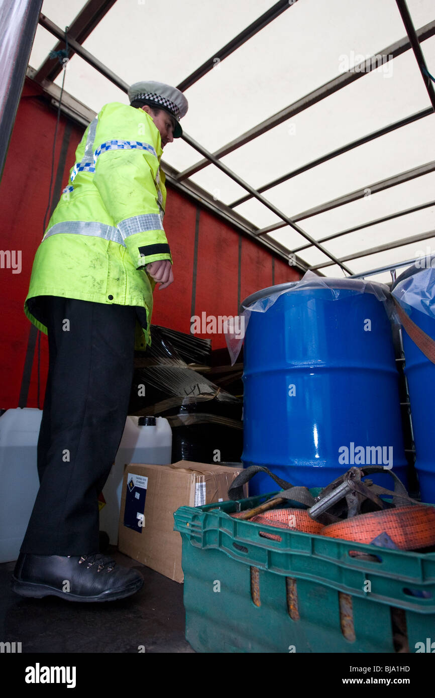 A police officer checking a loaded lorry Stock Photo - Alamy