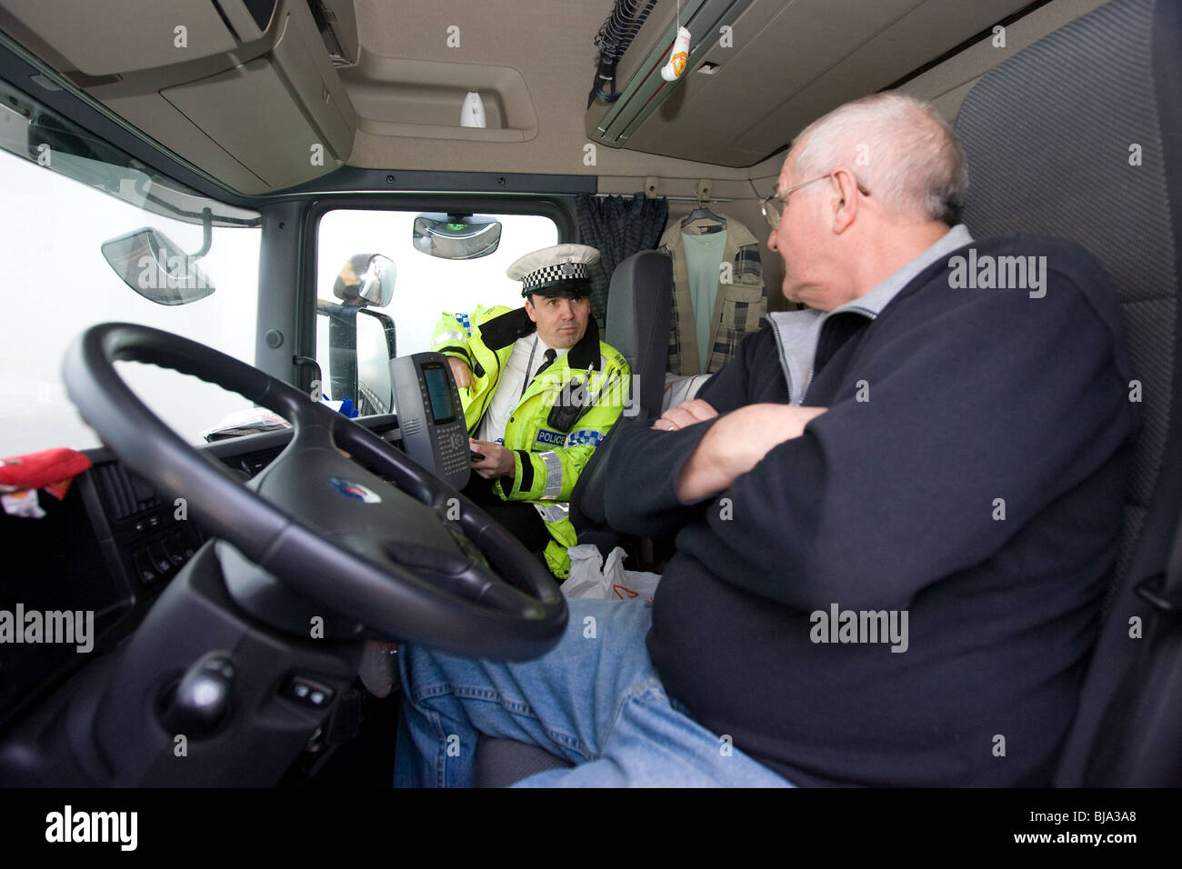 A Police Officer talking To A Lorry Driver in his cab Stock Photo - Alamy