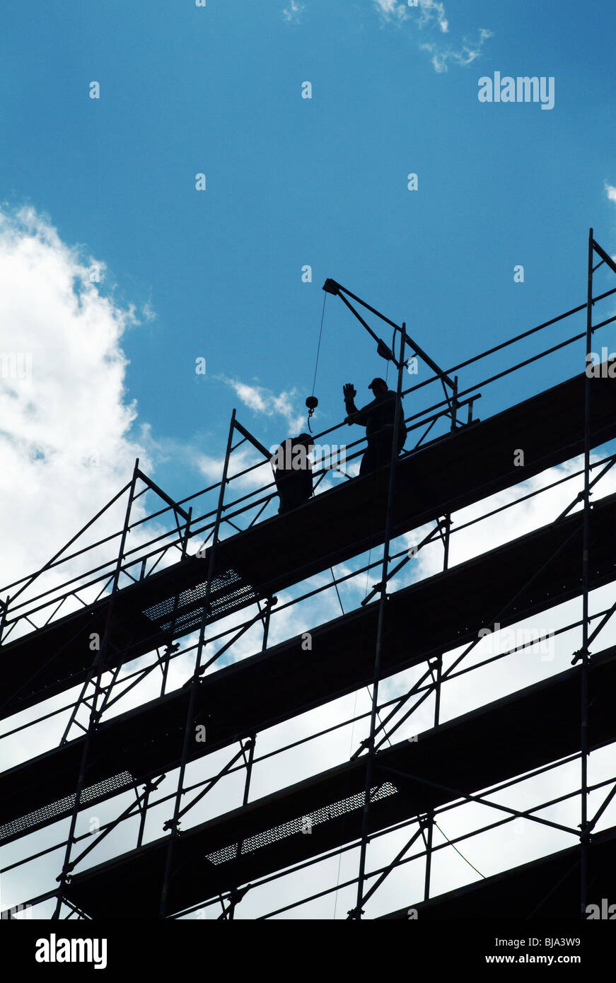 Construction workers on a scaffold Stock Photo - Alamy