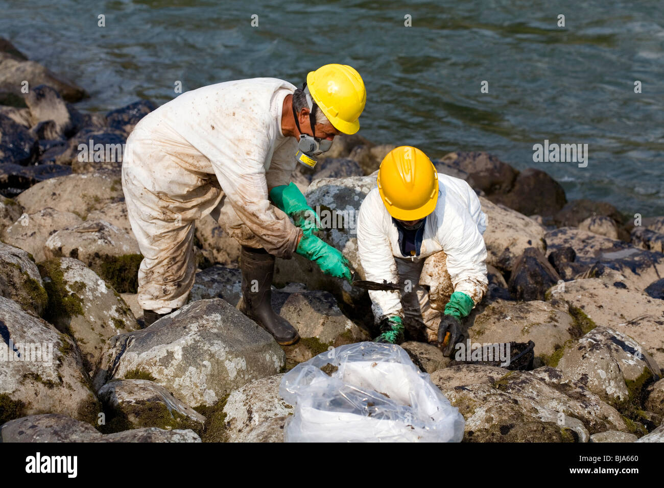 Cleaning up an oil spill on an Amazonian river Stock Photo - Alamy