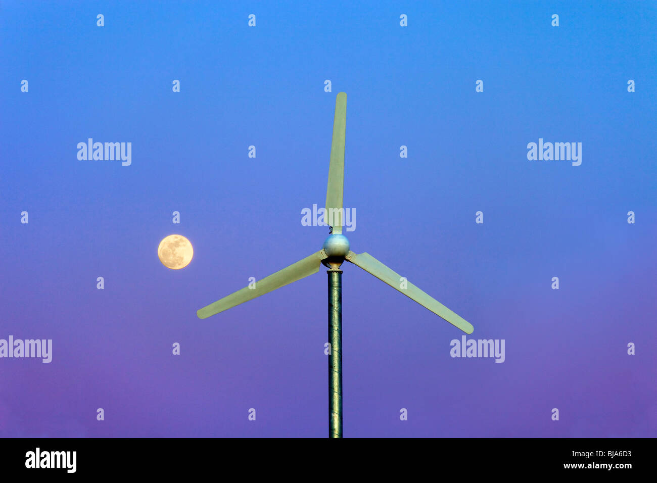 Windmill at dusk with the full moon rising behind it Stock Photo - Alamy