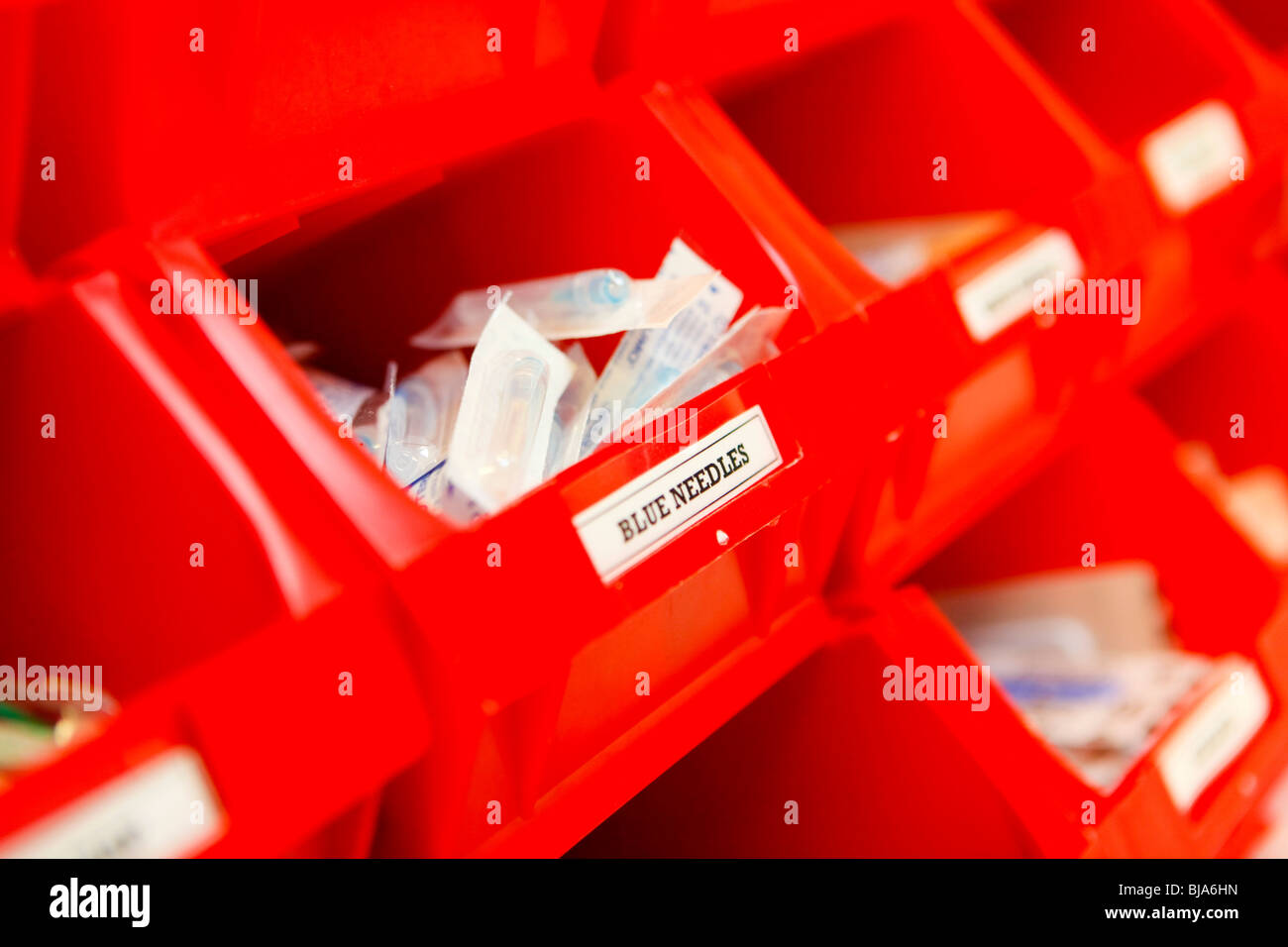 Red boxes for keeping needles in a hospital Stock Photo - Alamy