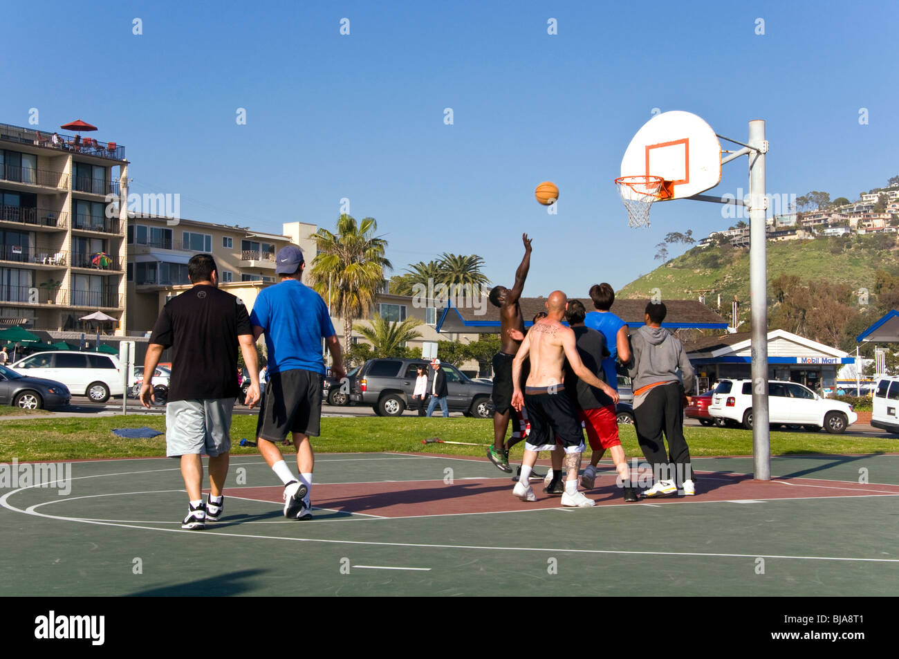 Men playing basketball on the California beach Stock Photo - Alamy