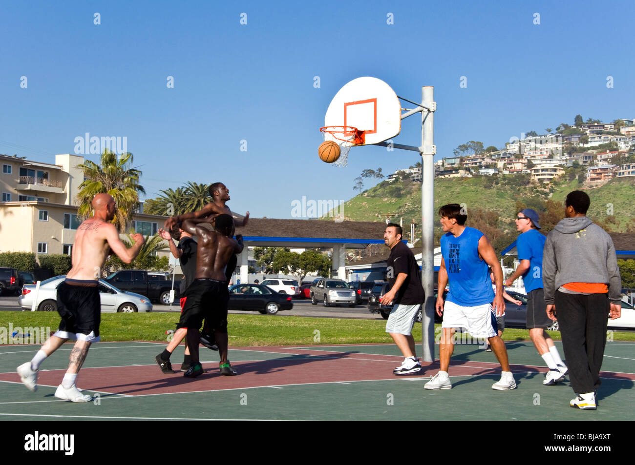 Men playing basketball on the California beach Stock Photo - Alamy