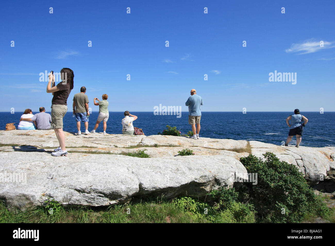 Tourists taking pictures and admiring the view of the Atlantic Ocean ...