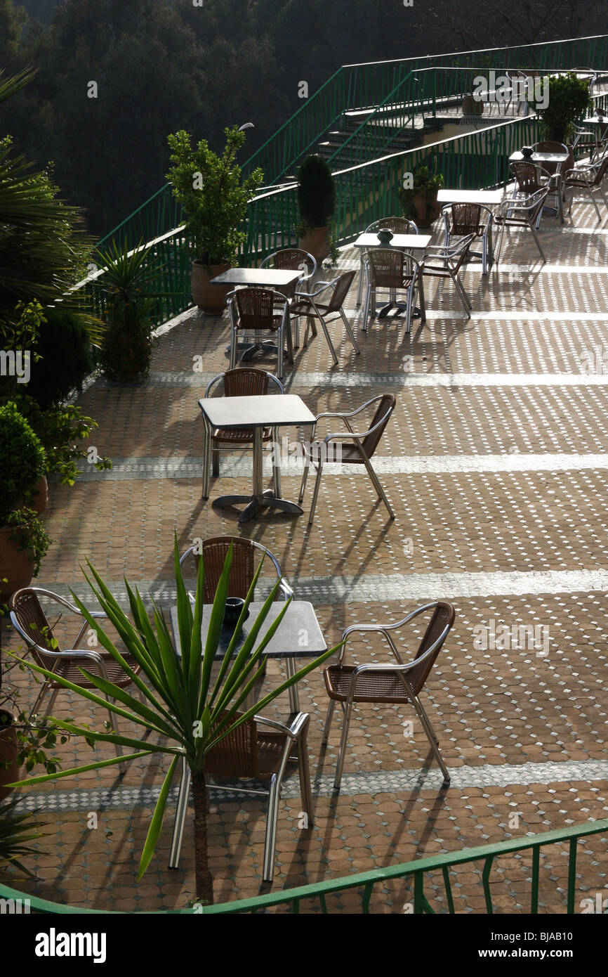Tables and chairs on a terrace at sunrise Stock Photo - Alamy