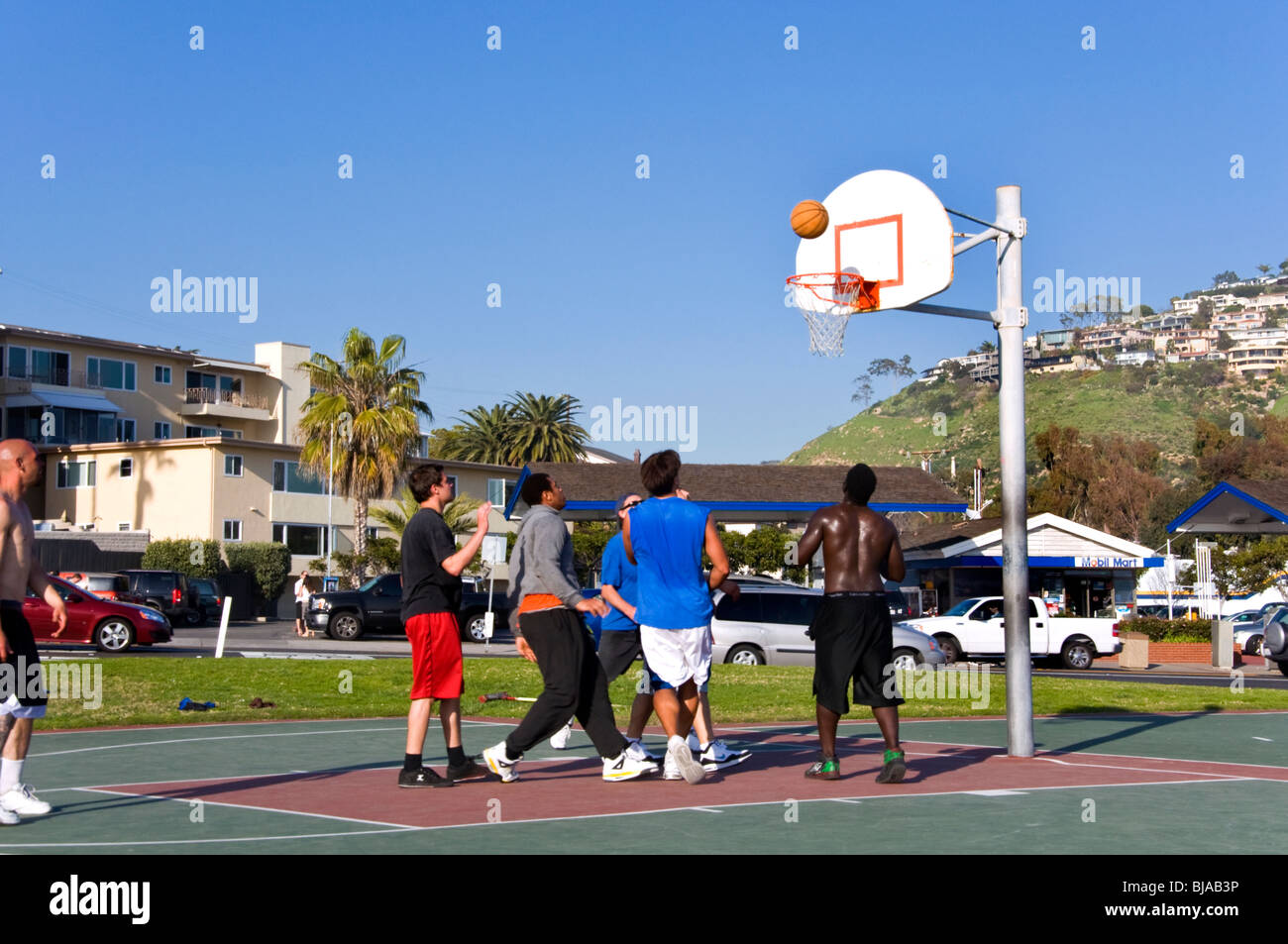 Men playing basketball on the California beach Stock Photo - Alamy